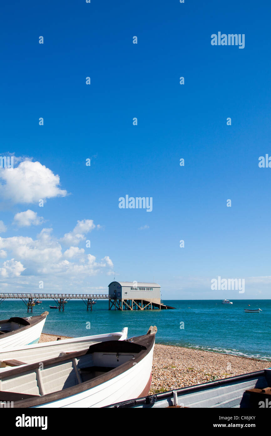 Boats on Selsey beach with lifeboat station in the background, West ...