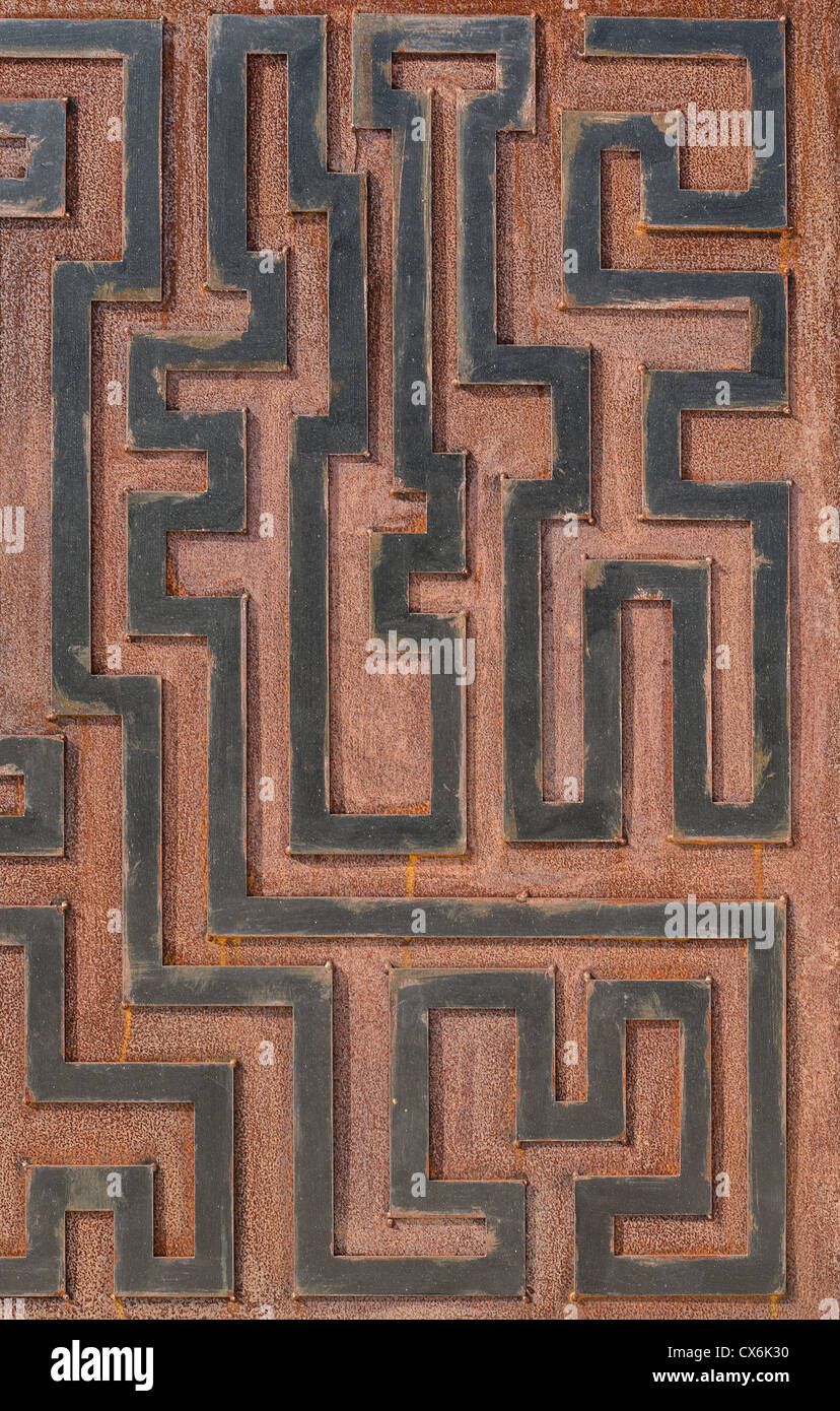 Metal rusty background, with geometrical shapes forming a labyrinth ...