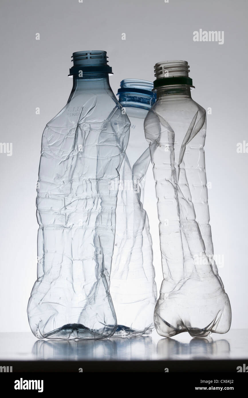 Three empty, partially crushed plastic water bottles Stock Photo - Alamy