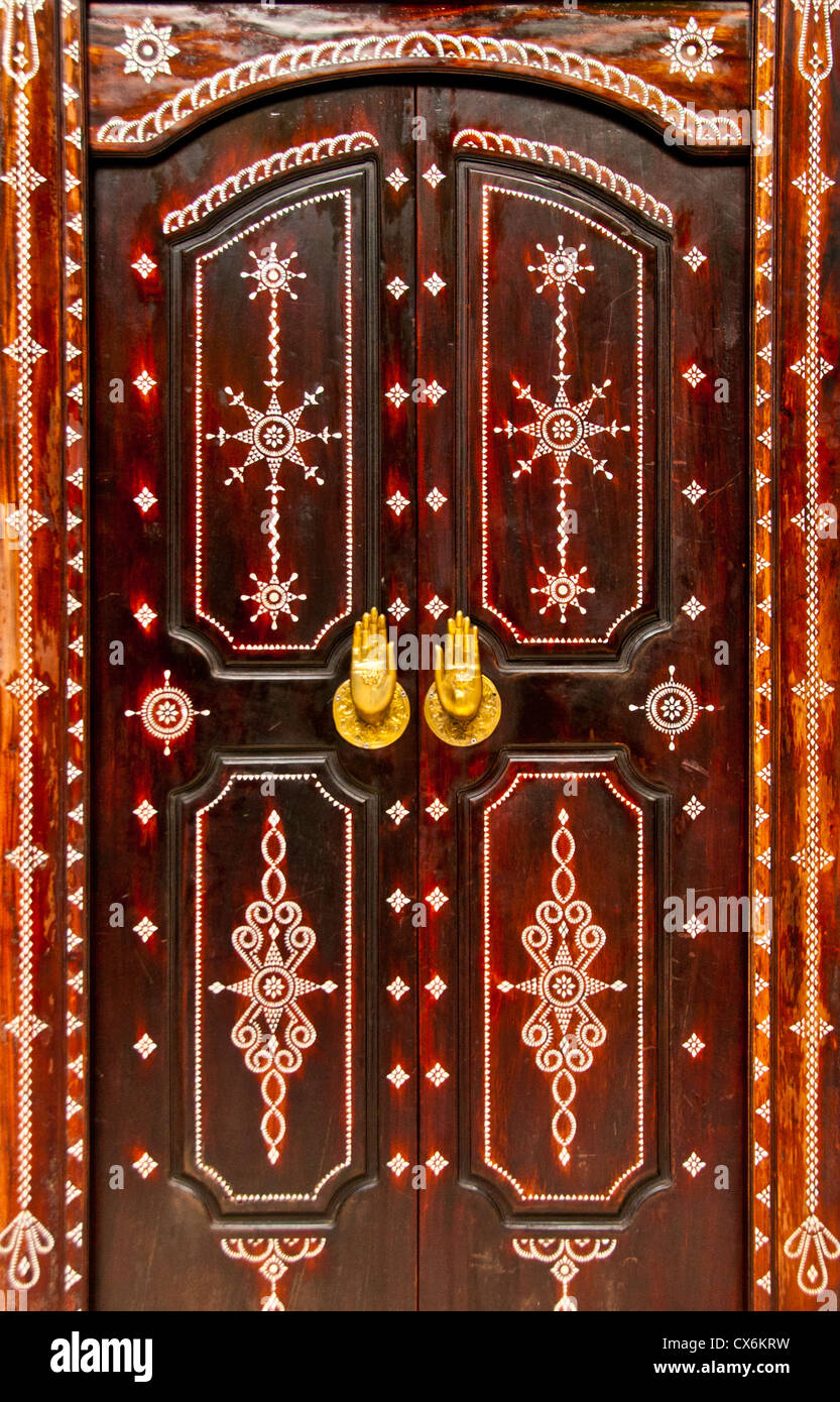 USA, Intricate door with golden hand door knobs in the Riveira Maya ...
