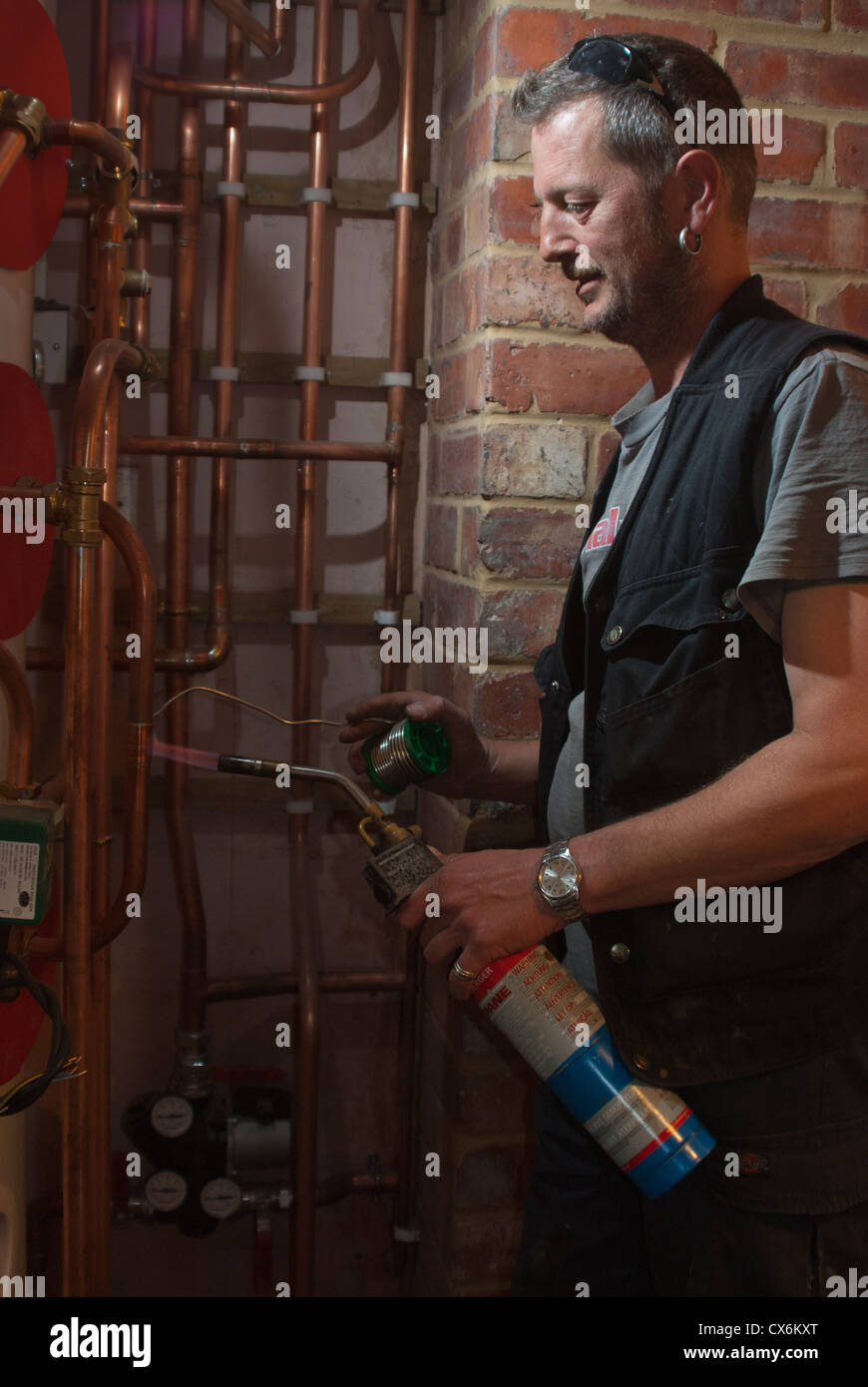 A plumber installing a solar thermal heating system Stock Photo - Alamy