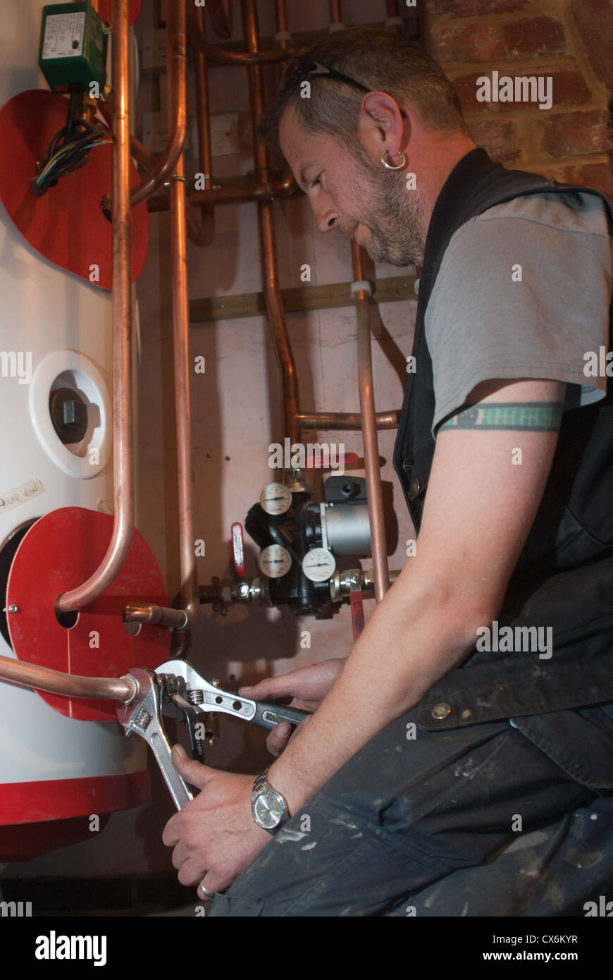 A plumber installing a solar thermal heating system Stock Photo - Alamy