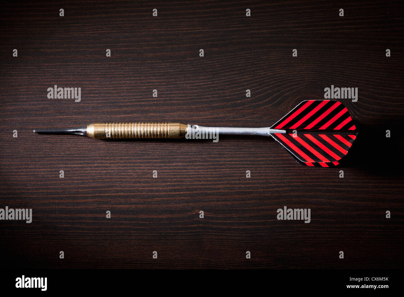 A single dart lying on its side Stock Photo - Alamy