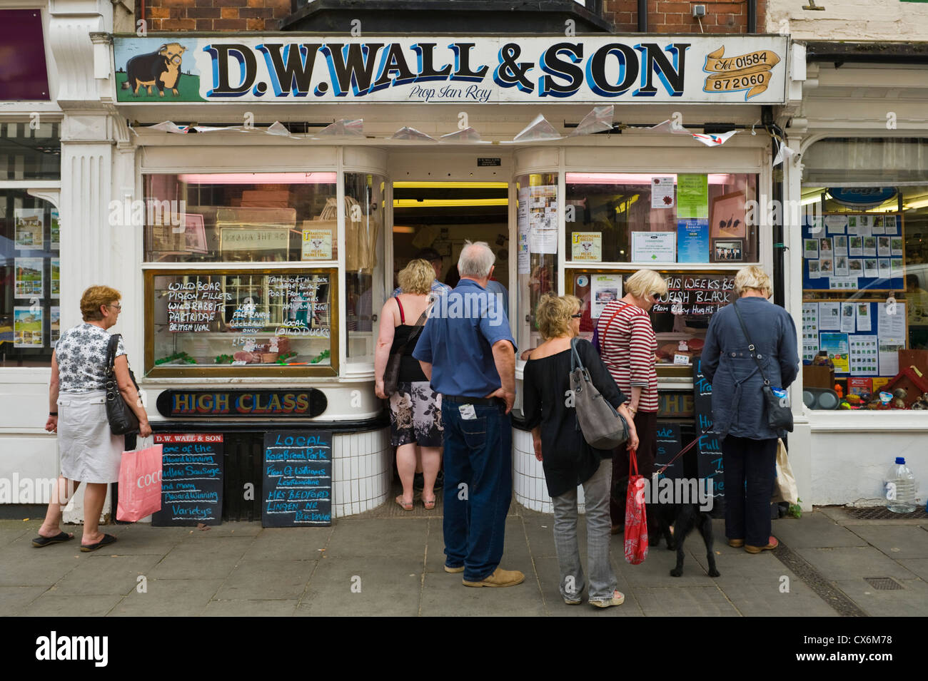 Exterior of butchers shop with people outside in Ludlow Shropshire ...