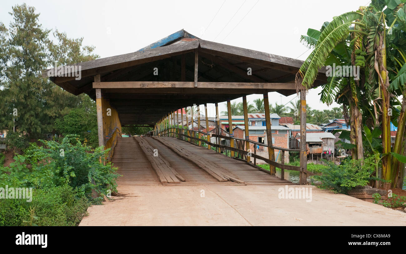 Old, wooden bridge with a roof crossing the Serei Sophorn River in ...