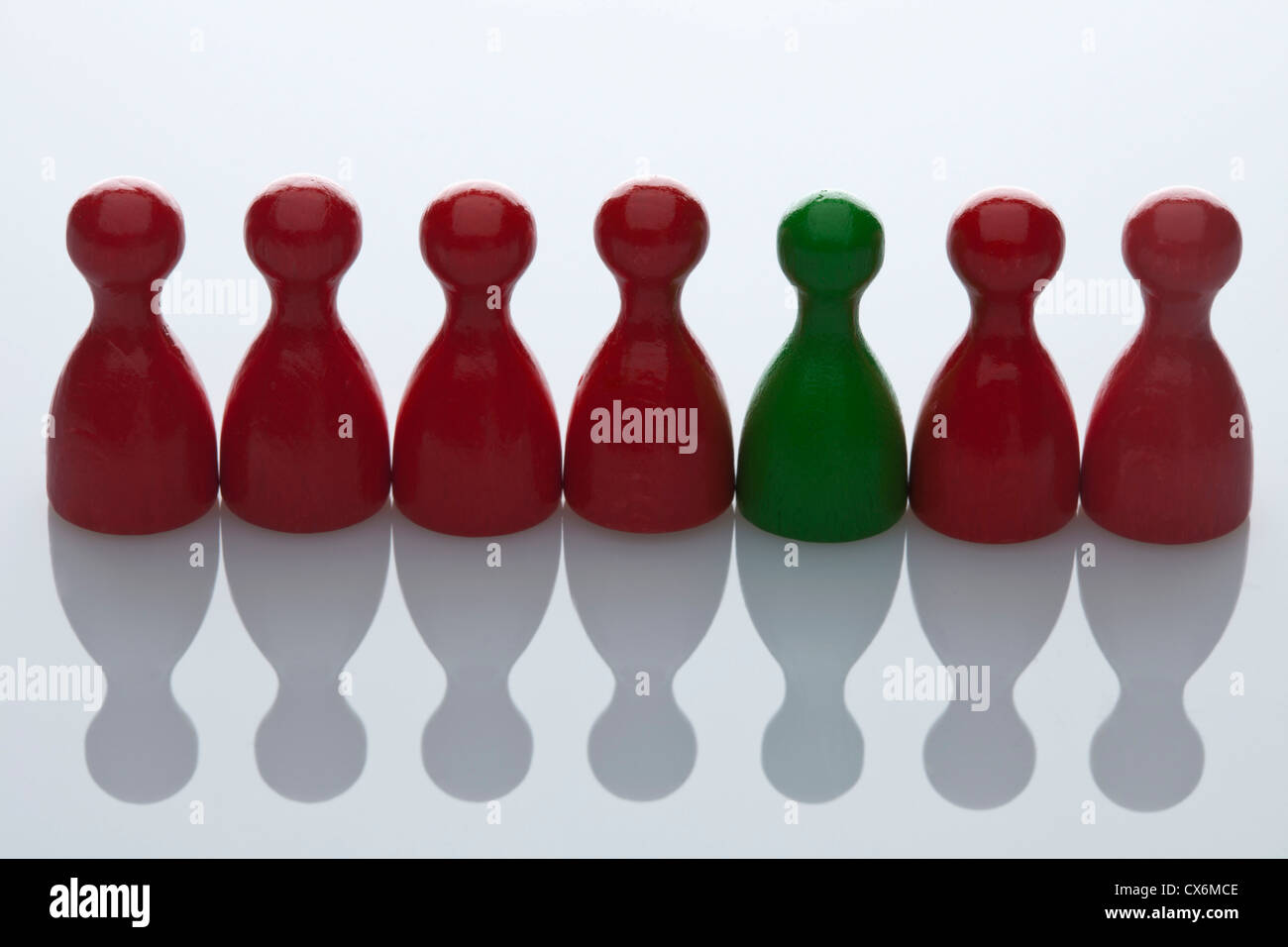 Six red game markers and one green game marker in a row Stock Photo - Alamy