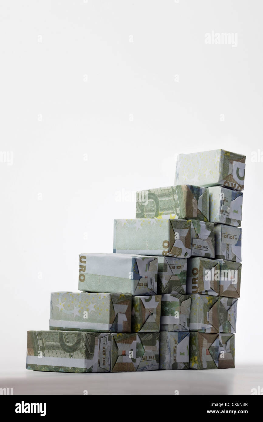 Five Euro banknotes folded into rectangular boxes and arranged into a ...