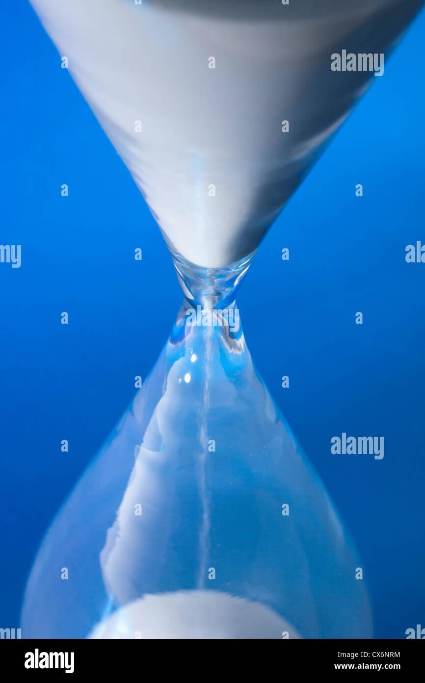 Sand running through an hourglass, close-up Stock Photo - Alamy