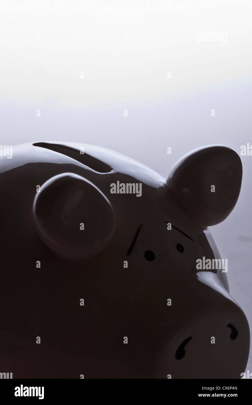 A piggy bank with raised eyebrows indicating worry Stock Photo - Alamy