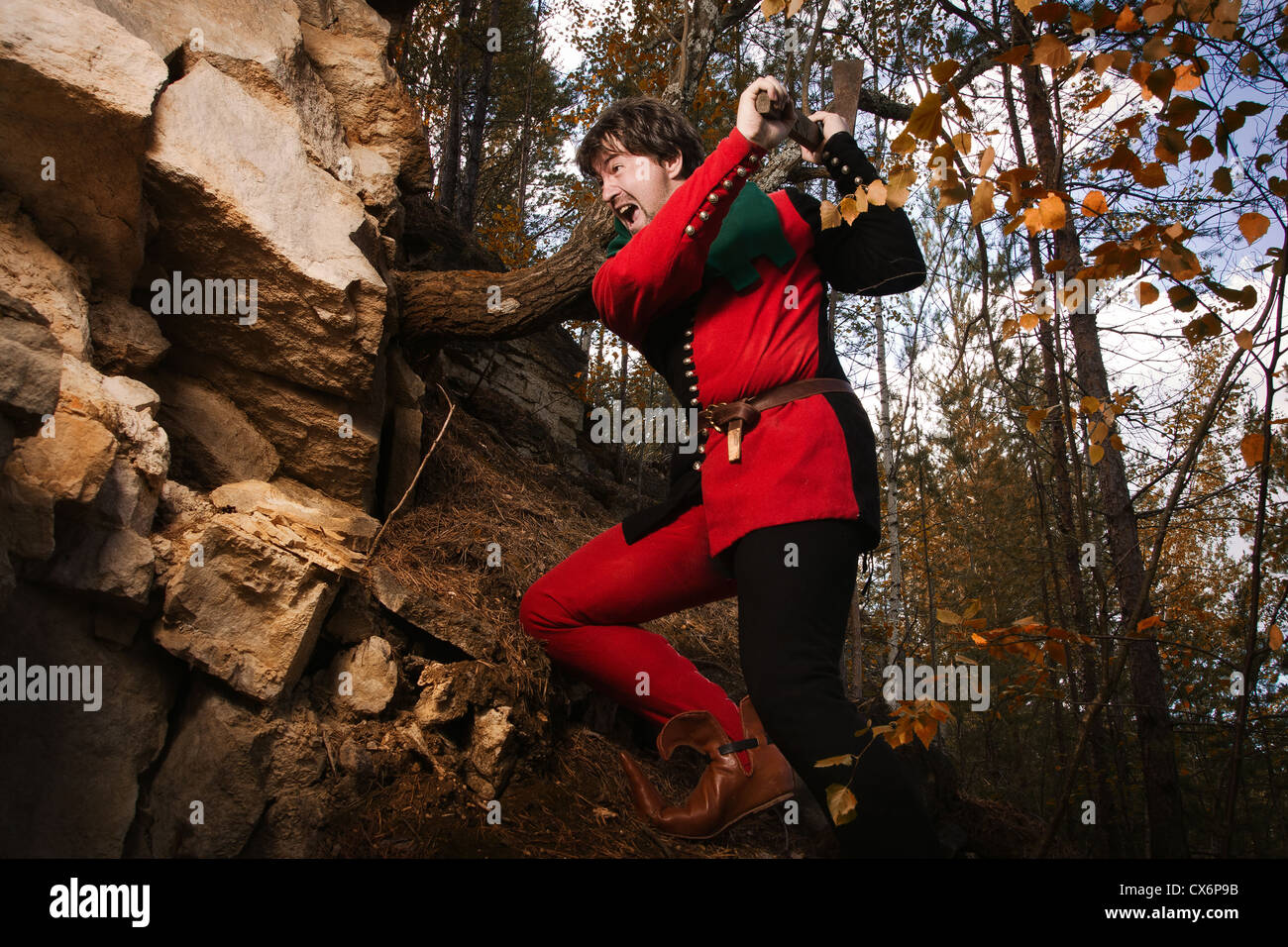Medieval miner with a pick on the mountain Stock Photo - Alamy