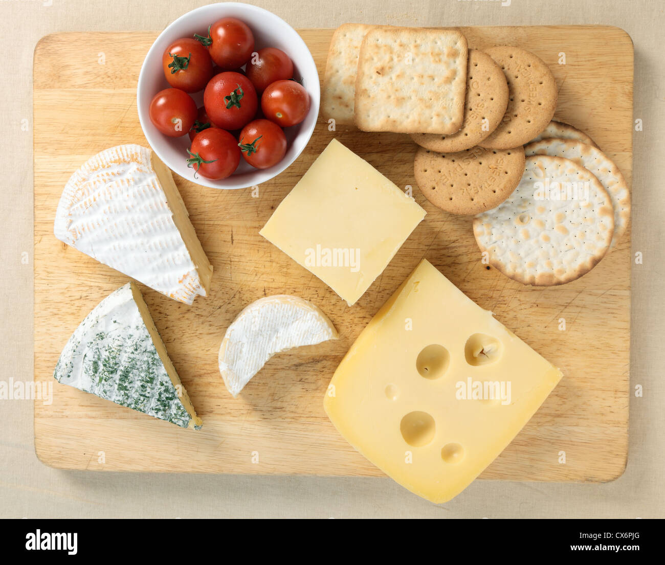 A cheeseboard with Jarlsberg, Cheddar, herbed Brie, Camembert and St ...