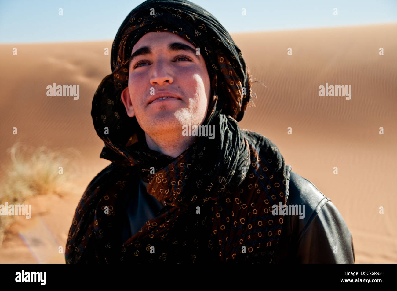 A young Berber man smiling in the Saharan Desert Stock Photo - Alamy