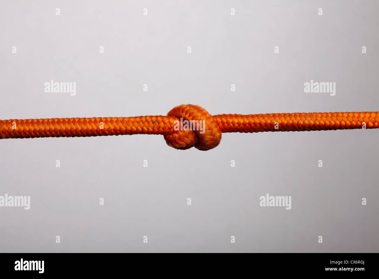 An orange rope with a knot in it Stock Photo - Alamy