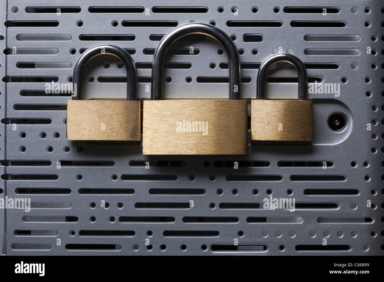 Three padlocks lying on the back of a computer hard drive Stock Photo ...