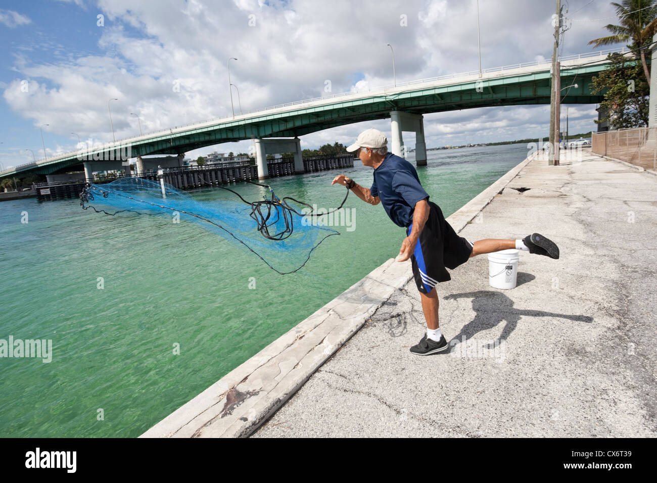 Fisherman throwing cast net from land, Haulover Park Bayside, Miami ...