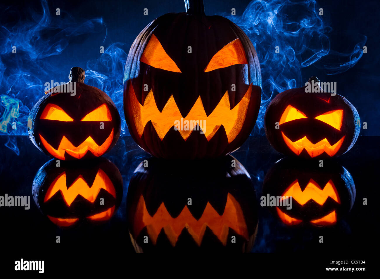 Three smoking pumpkins for Halloween celebration Stock Photo - Alamy