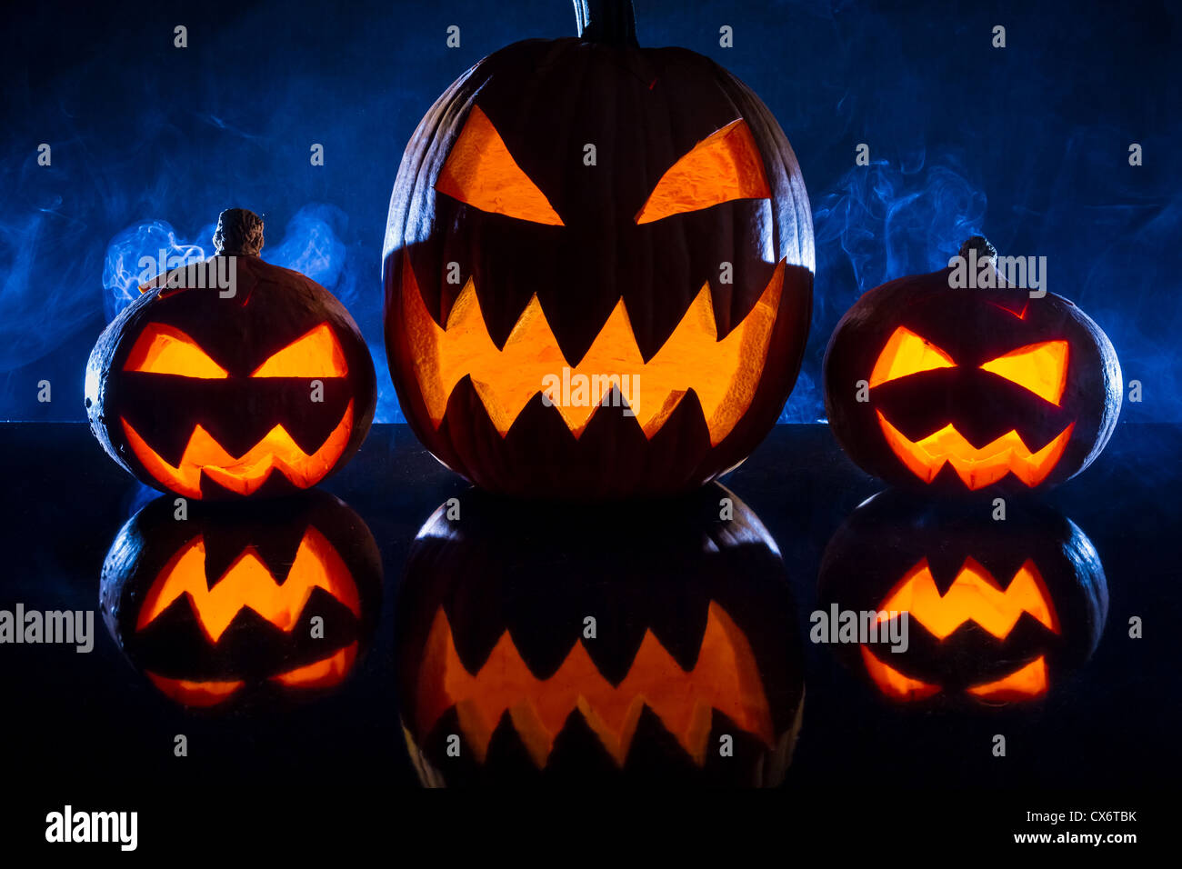 Three pumpkins for Halloween celebration Stock Photo - Alamy