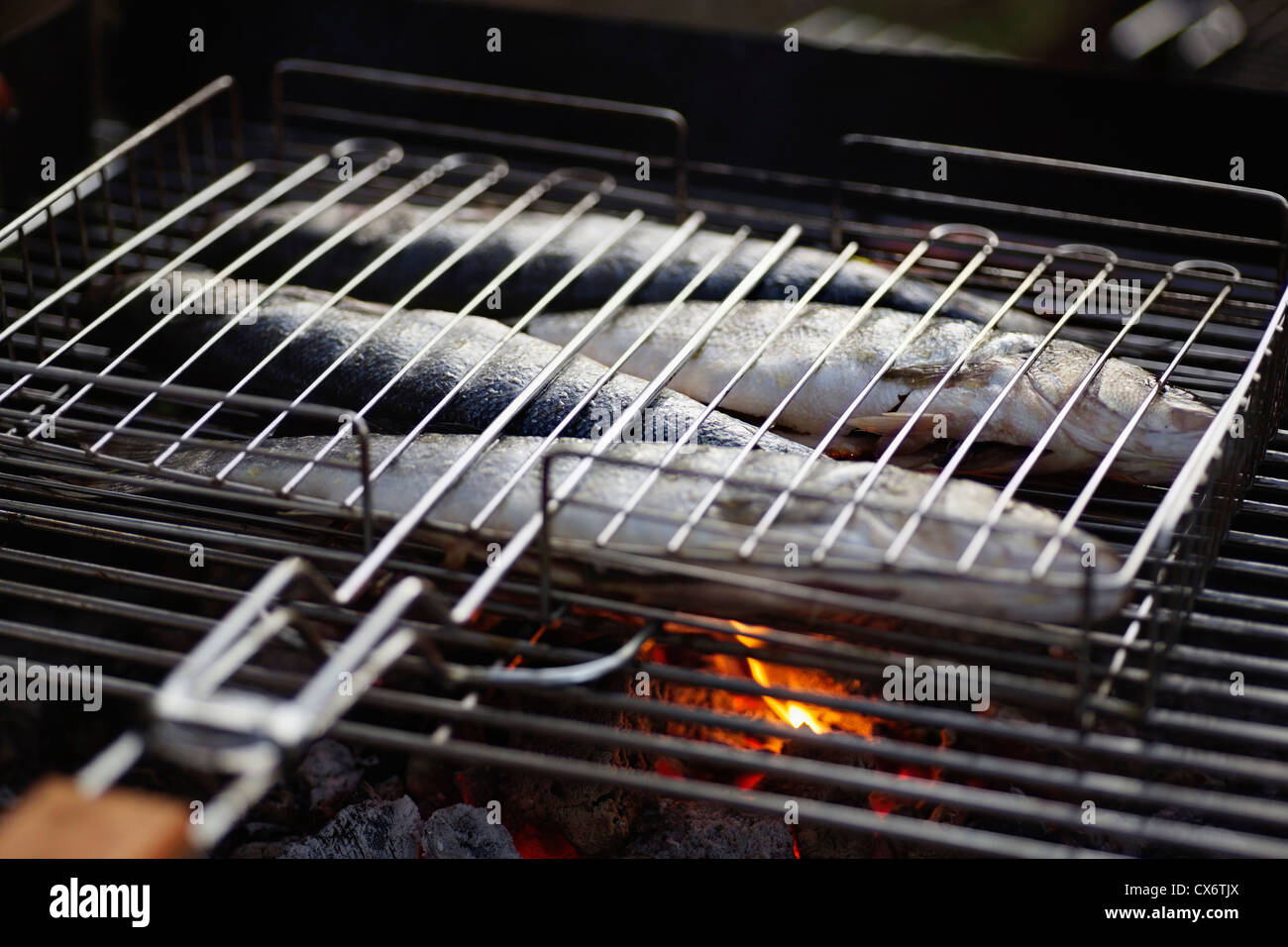 Fish on a barbeque grill Stock Photo - Alamy