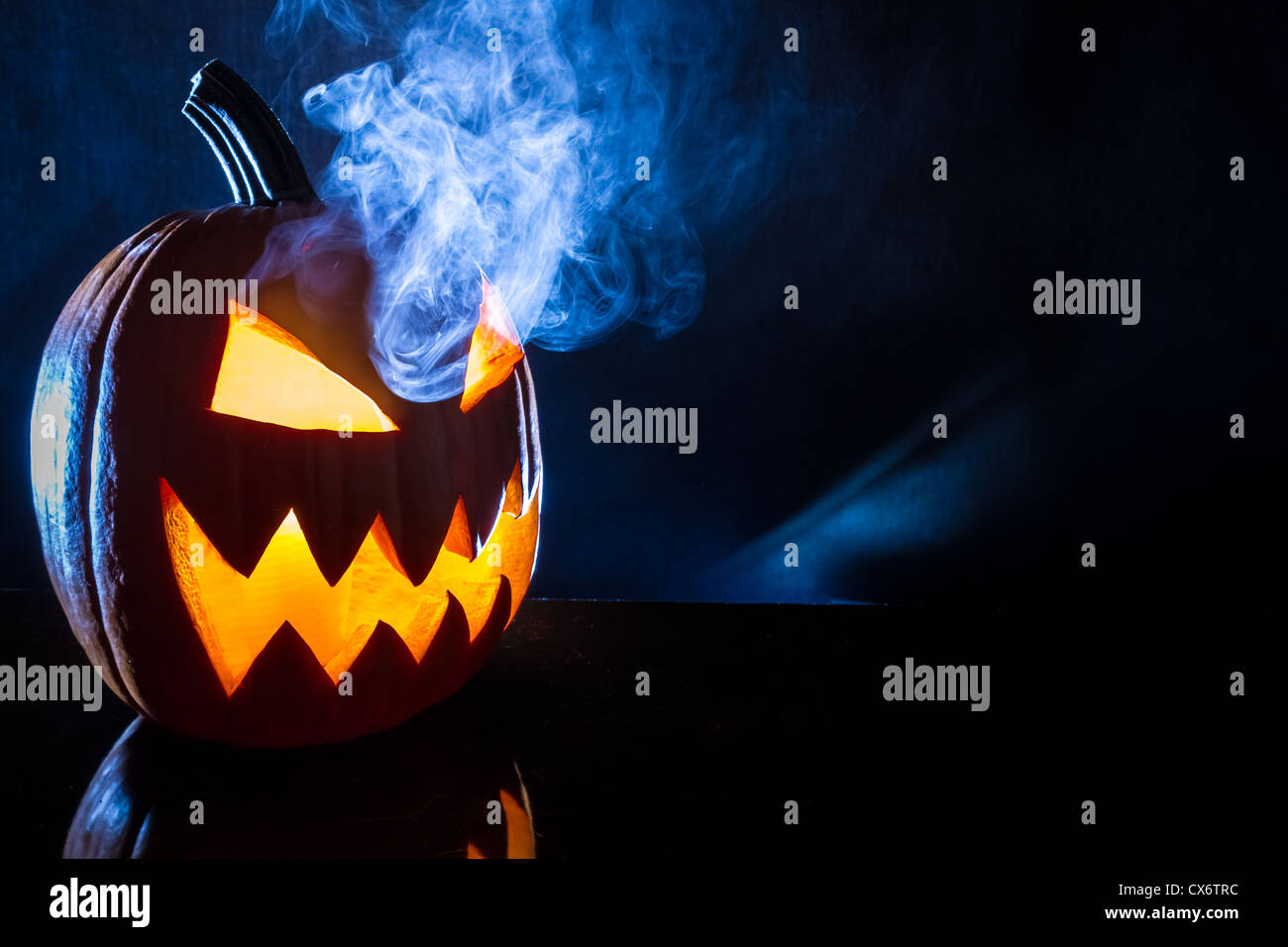 Smoking pumpkin with candle on Halloween Stock Photo - Alamy