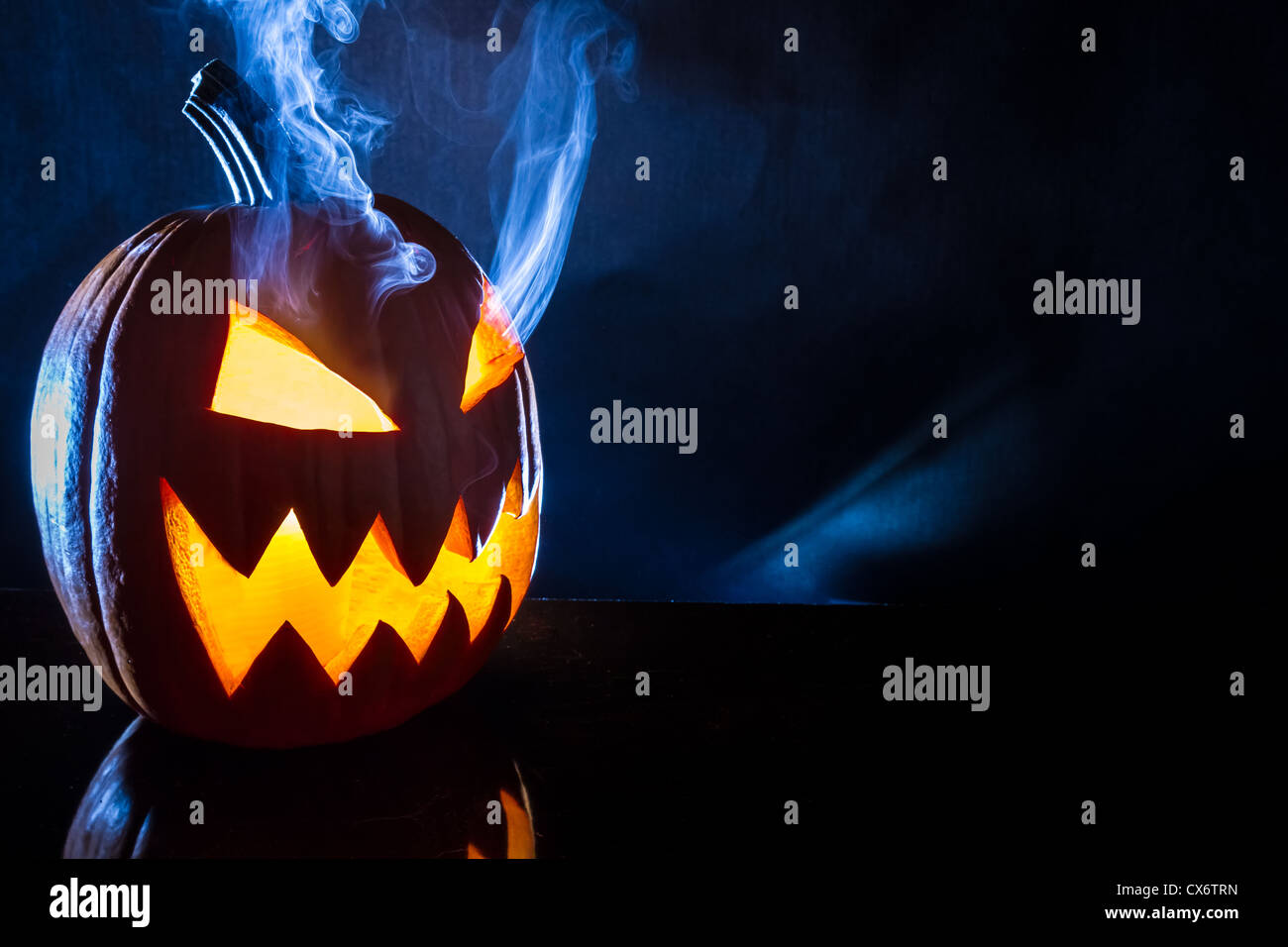 Smoking Halloween pumpkin head Stock Photo - Alamy