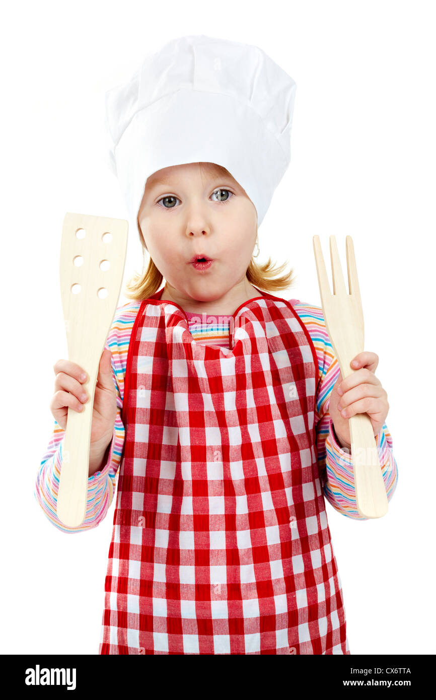 Girl in an apron and cook cap holding wooden kitchen tools Stock Photo ...