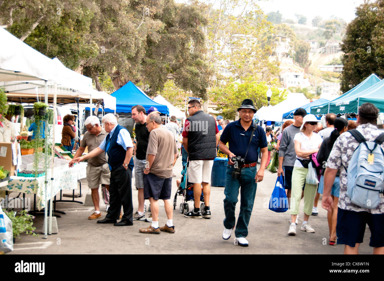 Photographer walking through crowd Stock Photo - Alamy