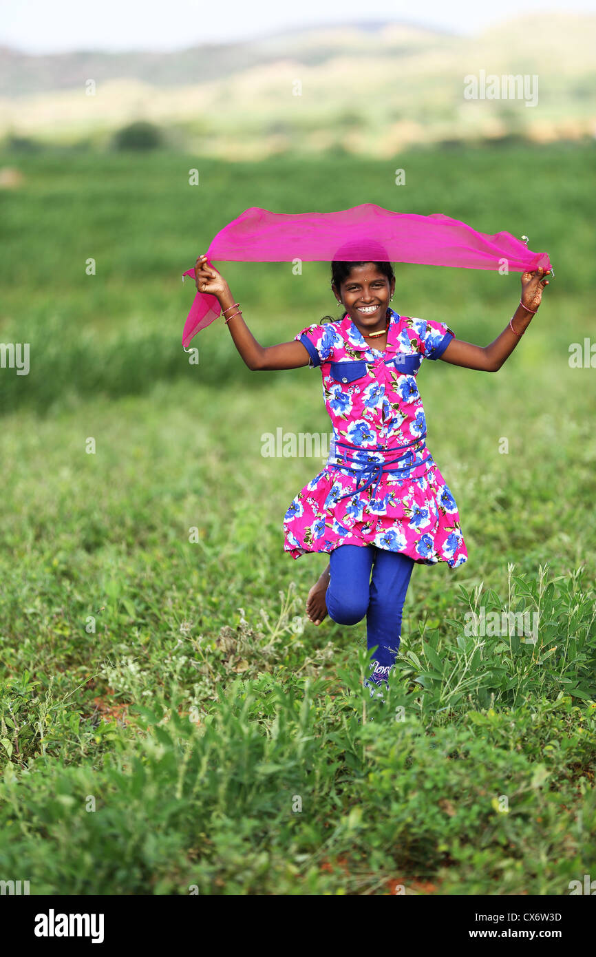 Indian girl running in a field Andhra Pradesh South India Stock Photo ...