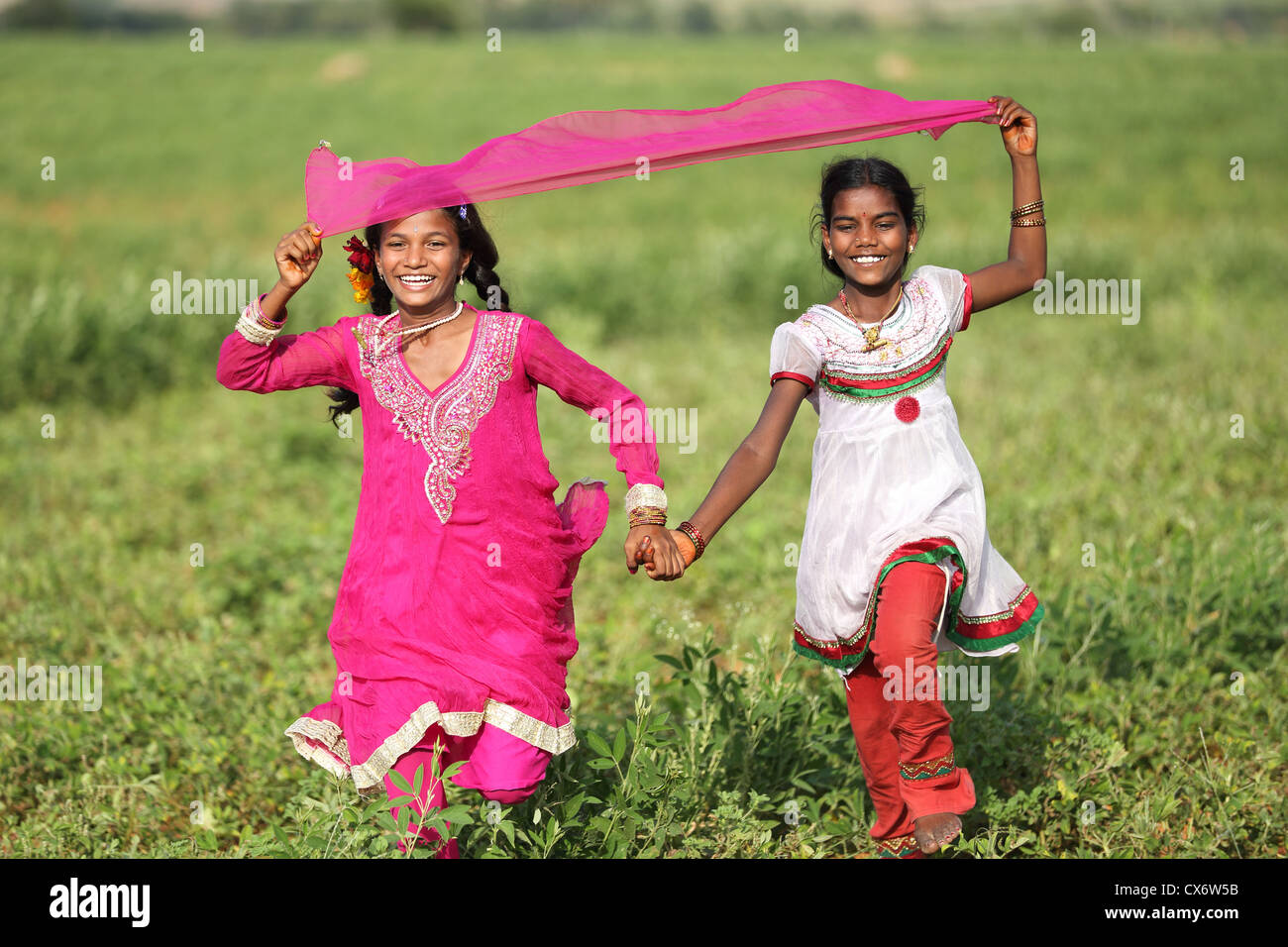 Indian girls running in a field Andhra Pradesh South India Stock Photo ...