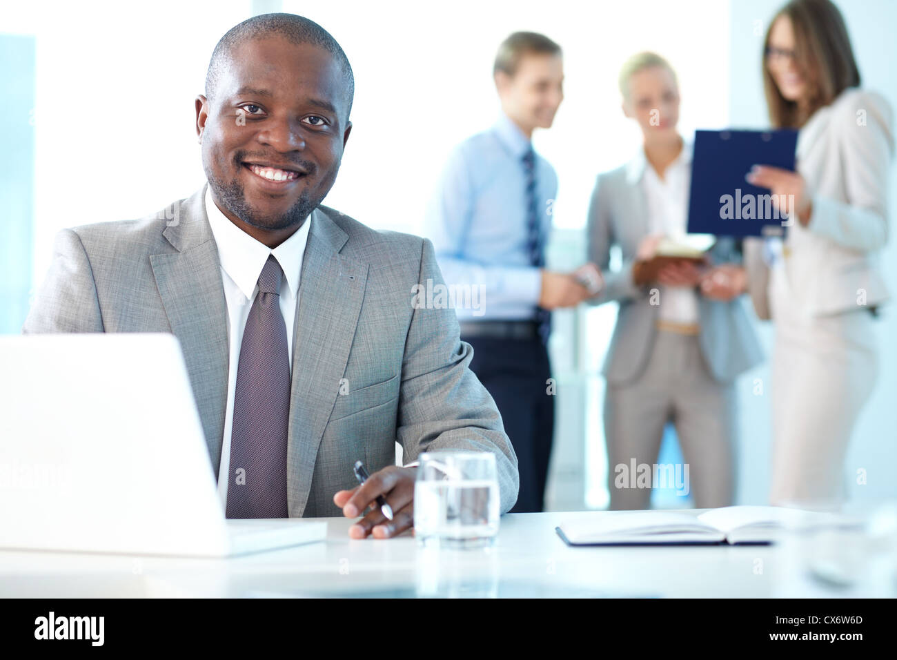 Portrait of happy boss looking at camera in working environment Stock ...