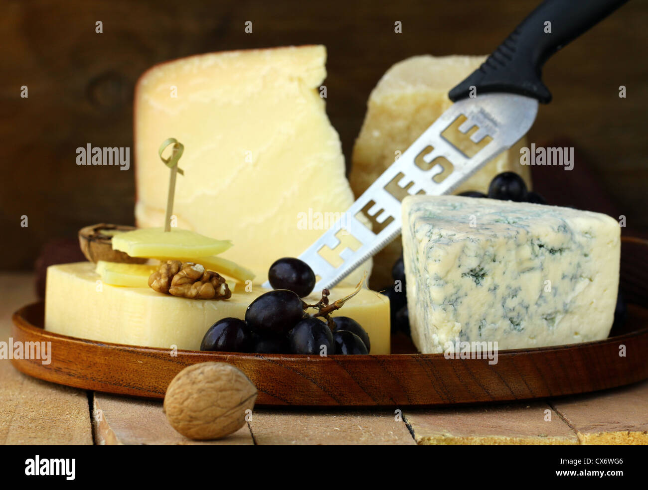 Still-life cheese platter with nuts and grapes Stock Photo - Alamy