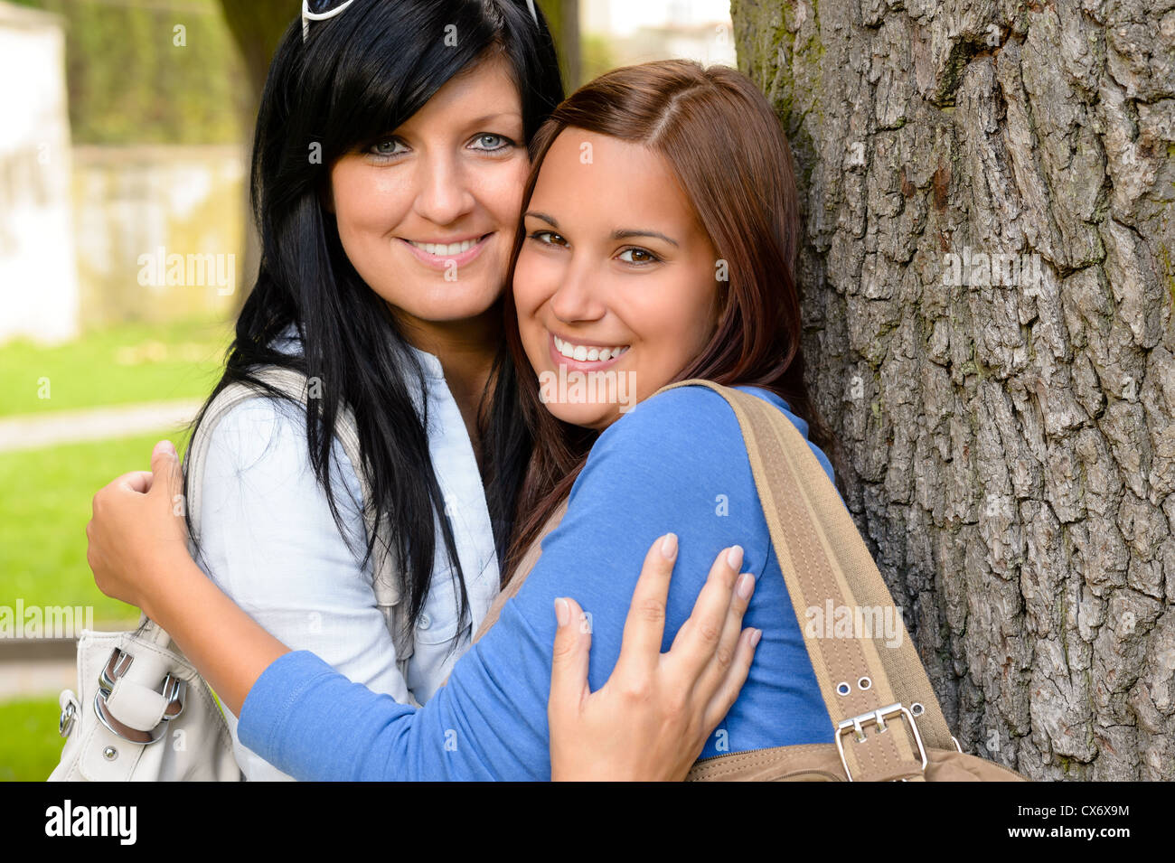 Mother and teen hugging outdoors relaxing smiling daughter bonding ...