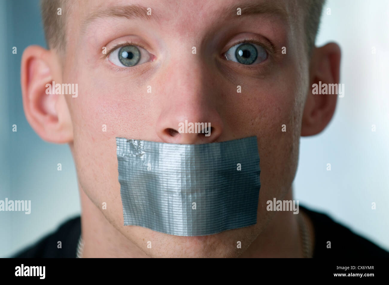 young man with mouth taped Stock Photo - Alamy