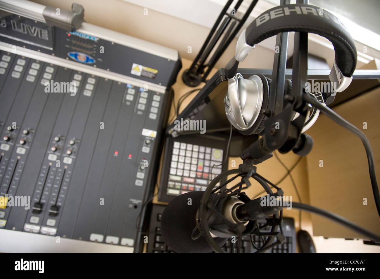 Sound desk with faders and microphone in recording studio Stock Photo ...