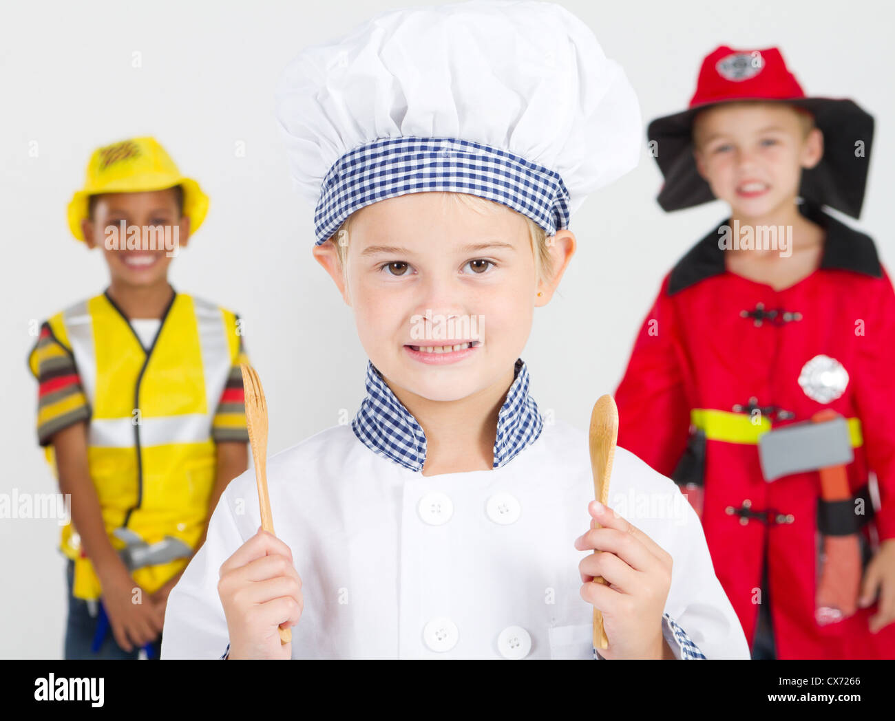 happy little chef in front of construction worker and fireman Stock ...