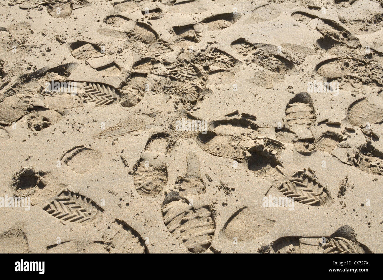 Concept of human activity - Multiple footprints on sandy beach ...
