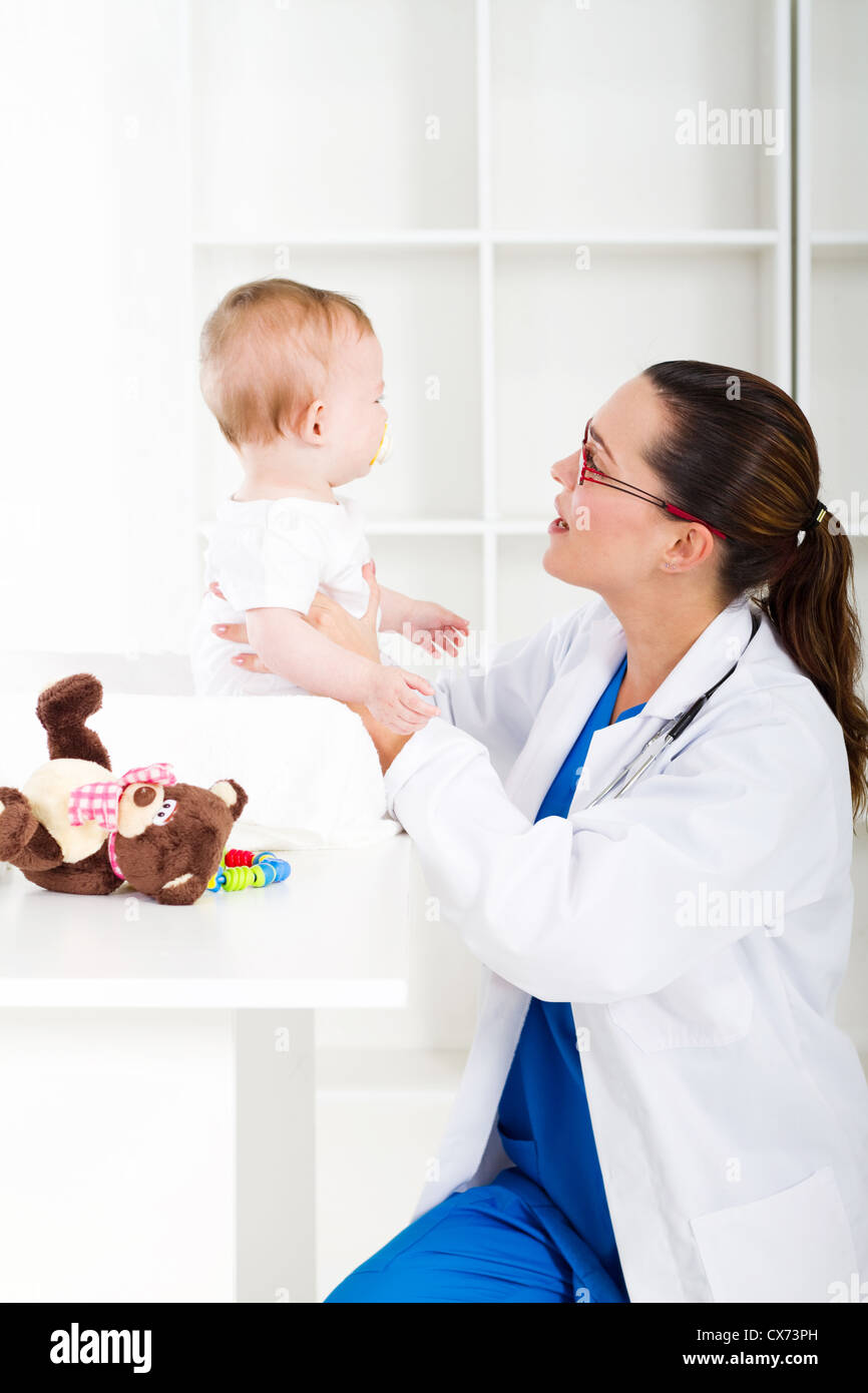 friendly female pediatrician and baby patient Stock Photo - Alamy