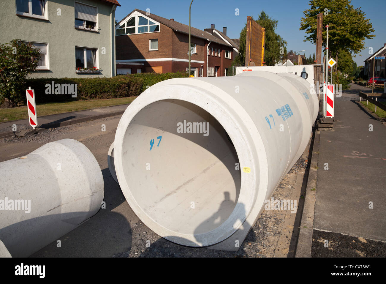 Sewage pipe in the street Stock Photo - Alamy
