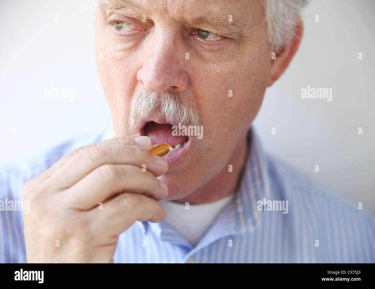 front view of man taking a dietary supplement Stock Photo - Alamy