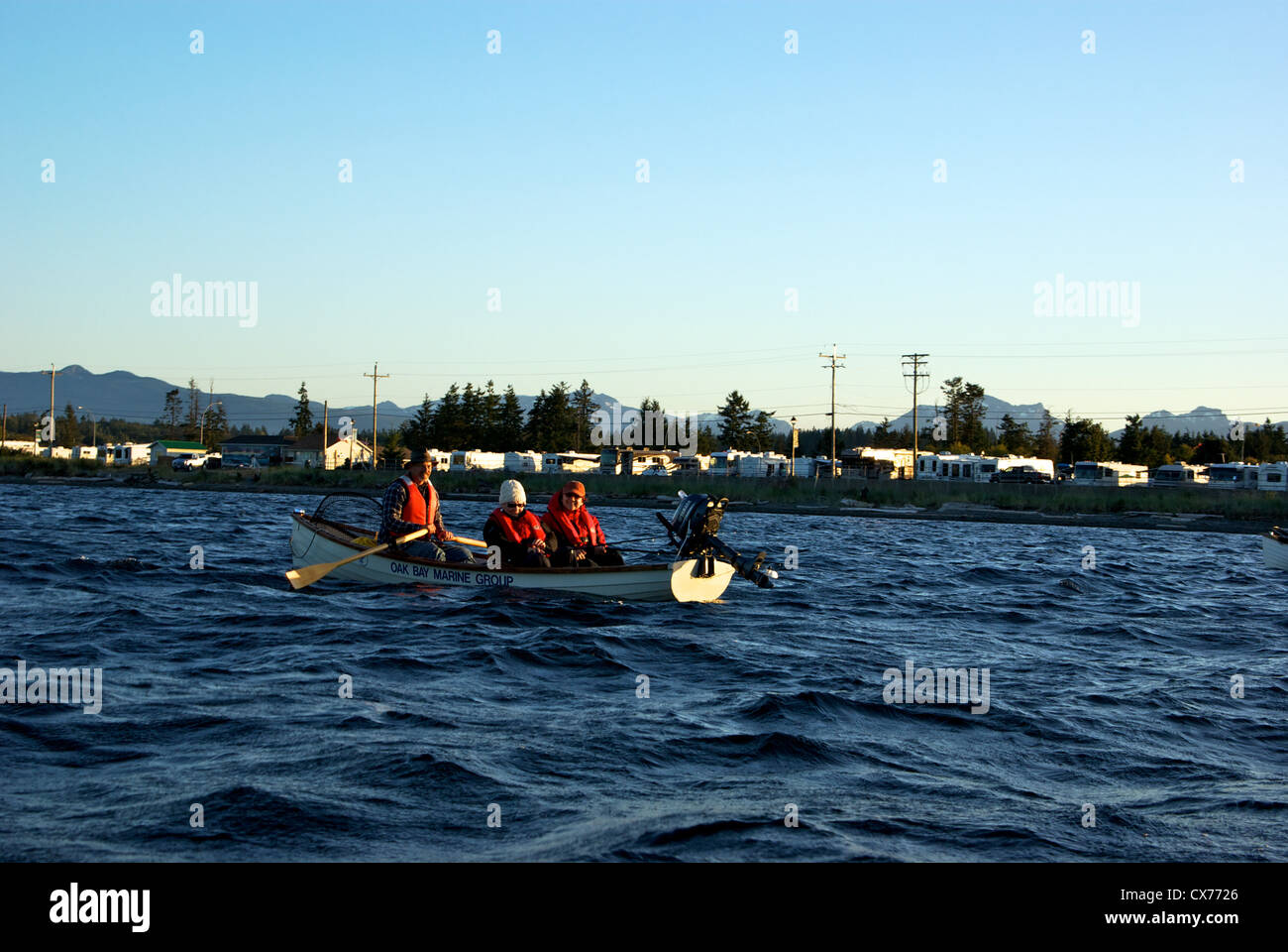 Two female anglers trying to catch big chinook salmon by row fishing in ...