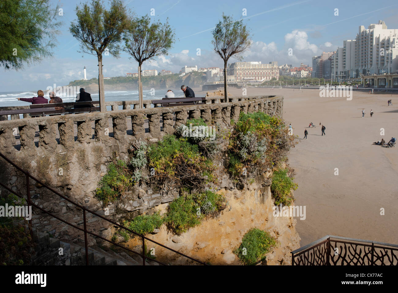 View of Biarritz with the beach and people watching the sea on benches ...