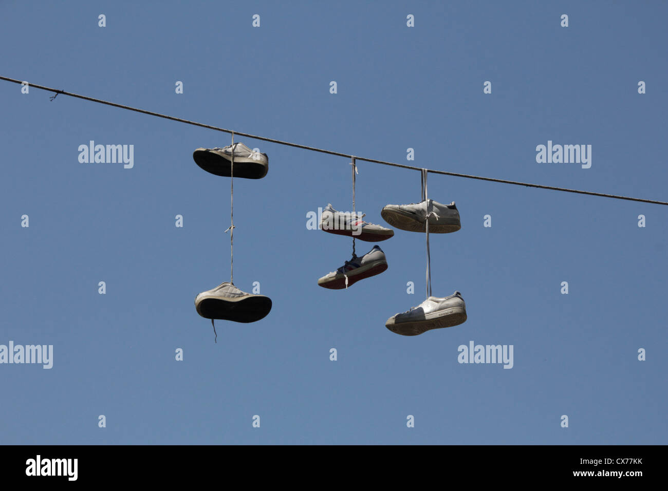 Shoes hanging from power lines hi-res stock photography and images - Alamy