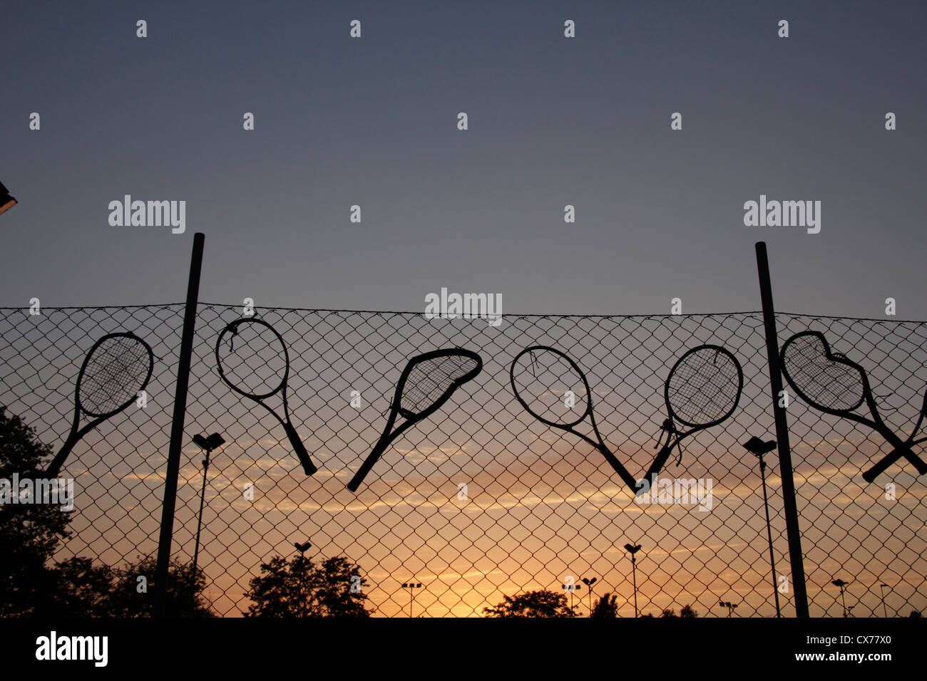 Old broken tennis rackets tied to fence at tennis club Stock Photo - Alamy