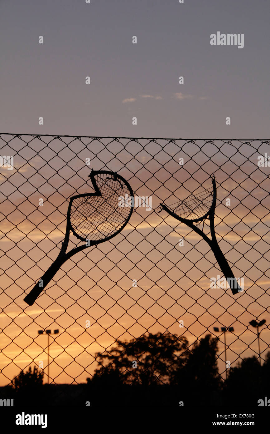 Old broken tennis rackets tied to fence at tennis club Stock Photo - Alamy