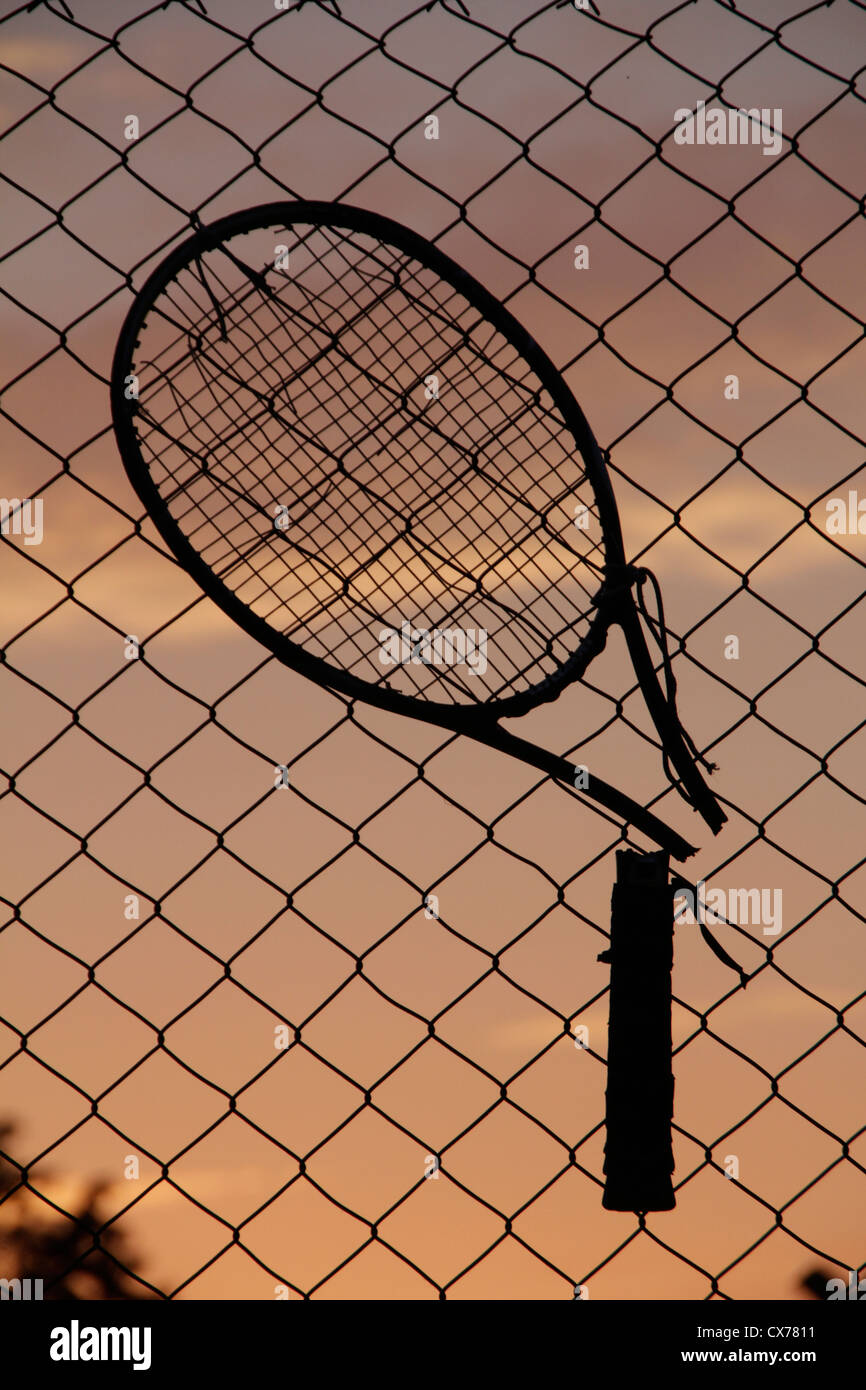 Old broken tennis rackets tied to fence at tennis club Stock Photo - Alamy