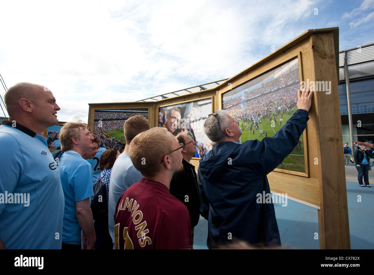 Fans look at the photo-boards outside the Etihad Stadium, Manchester ...