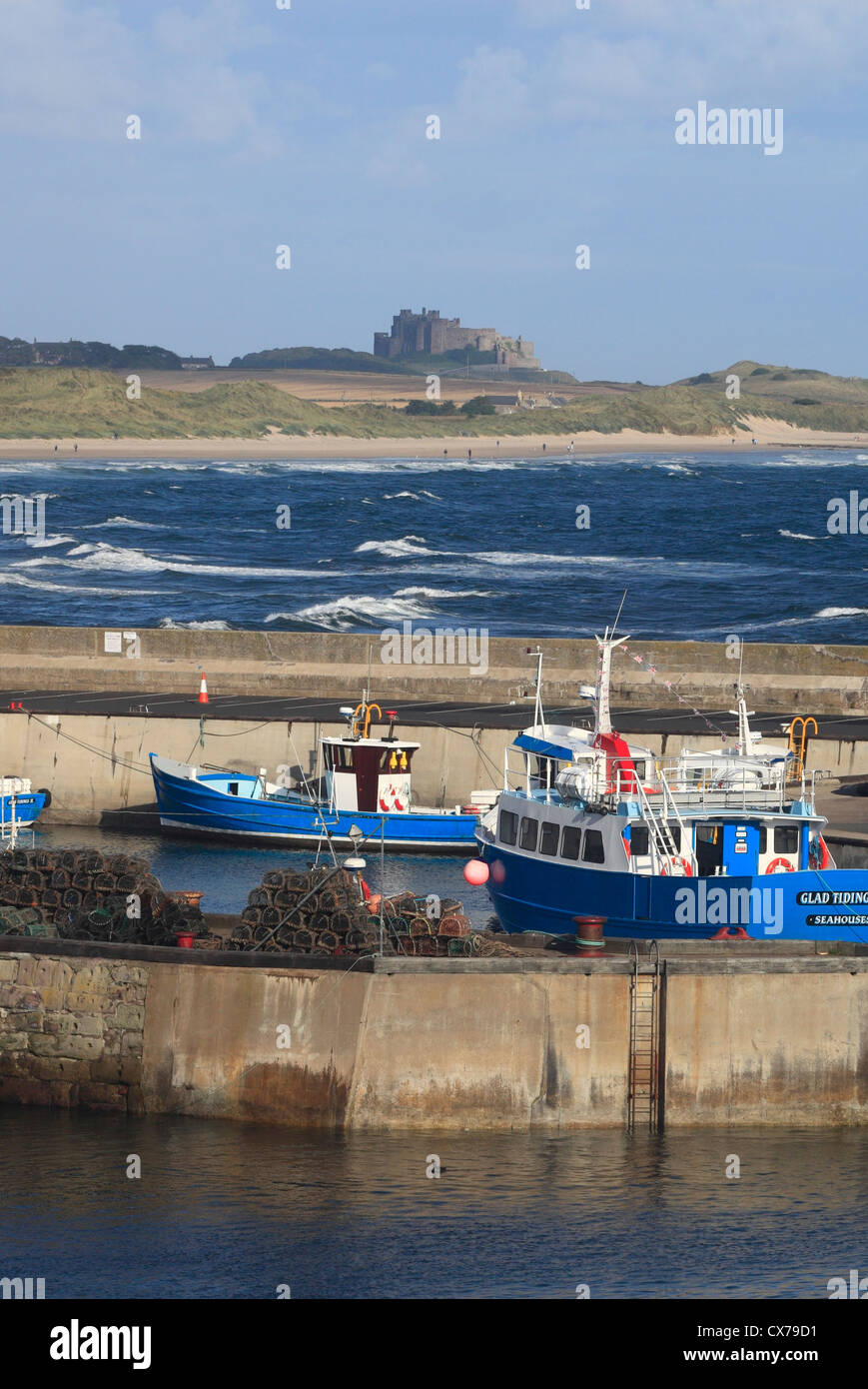 The harbour at Seahouses on the Northumberland coast with Bamburgh ...