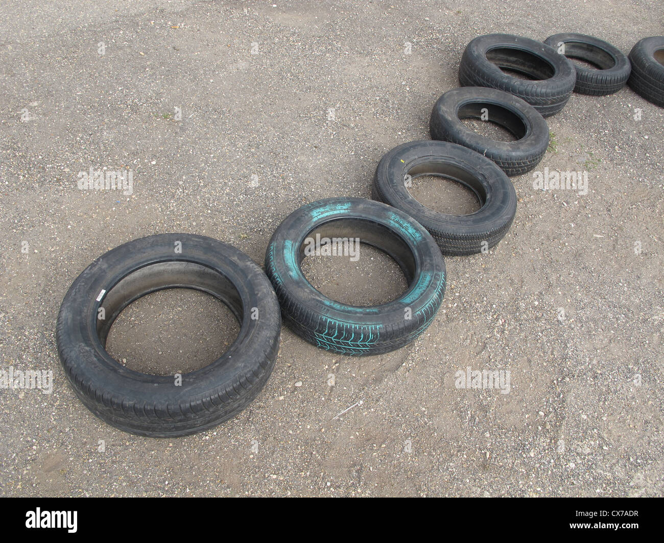 row of tyres used for game in playground Stock Photo - Alamy