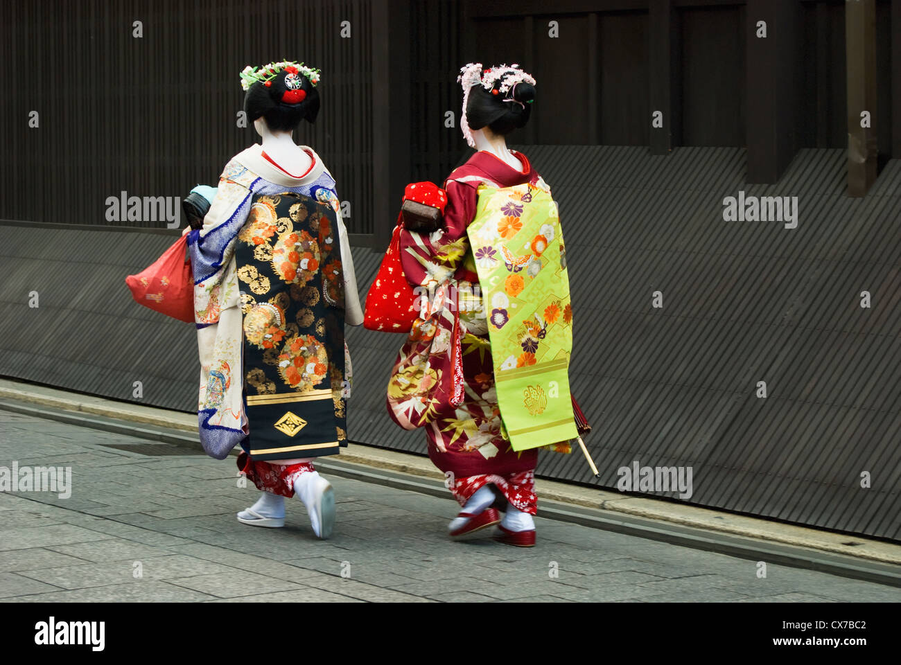 Two Maikos (Apprentice Geishas) Walking Away In A Street; Kyoto, Japan ...