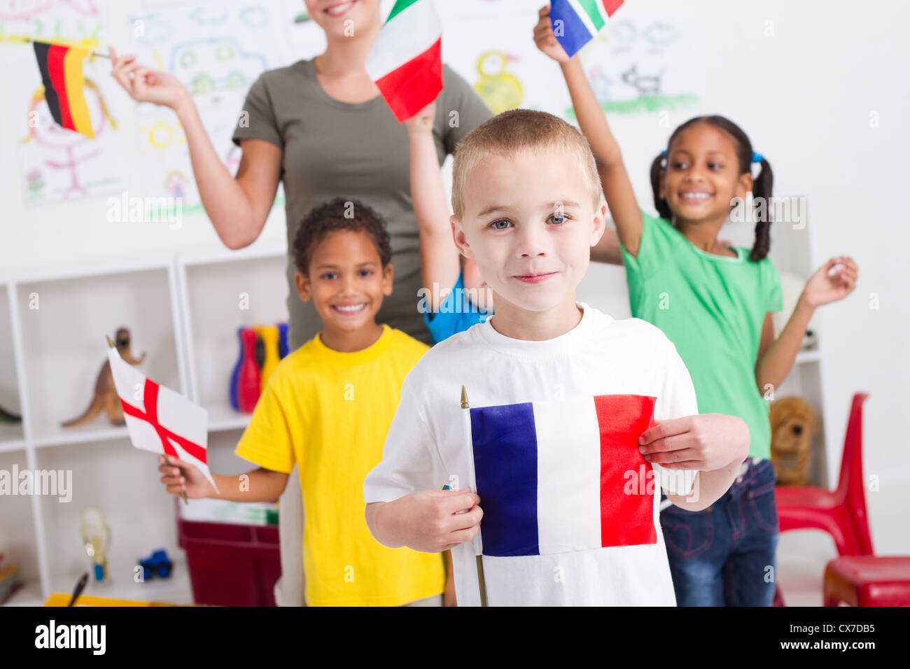 group of preschool kids and teacher with flags in classroom Stock Photo ...