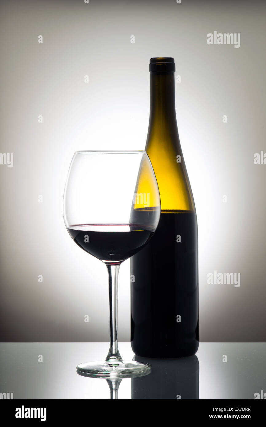 Bottle and glass of red wine with reflection on white background Stock ...